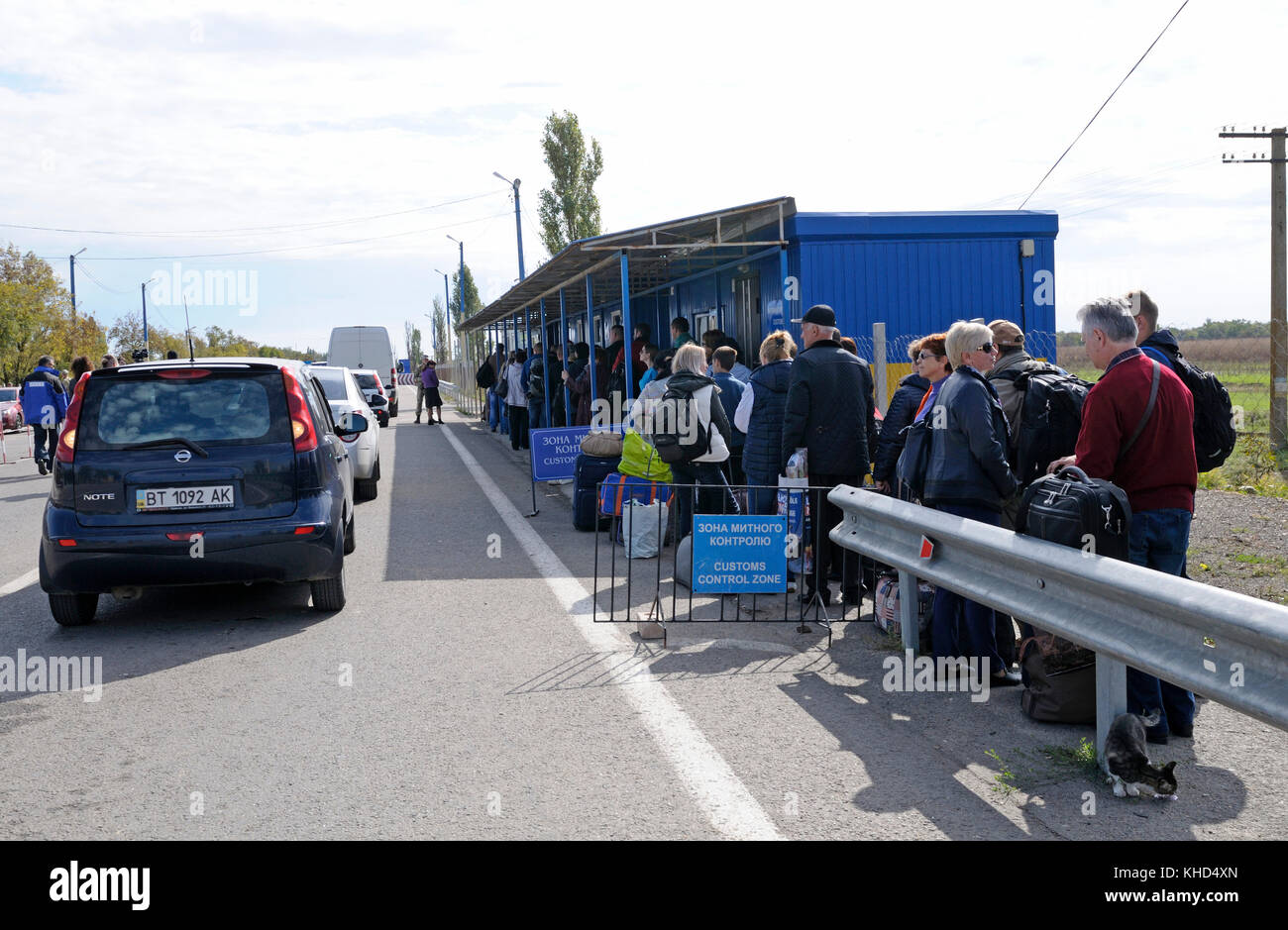 Travelers standing in line for passport control procedure at the border ...