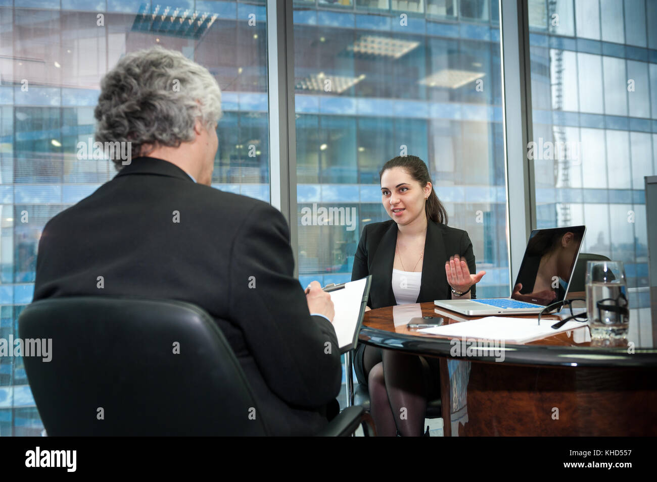 Boss interviews young employee Stock Photo - Alamy
