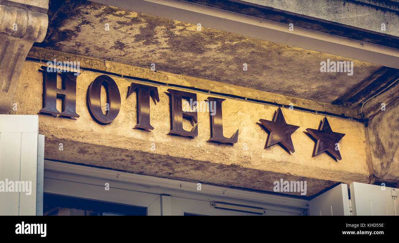 hotel sign on a stone wall with two stars in France Stock Photo - Alamy