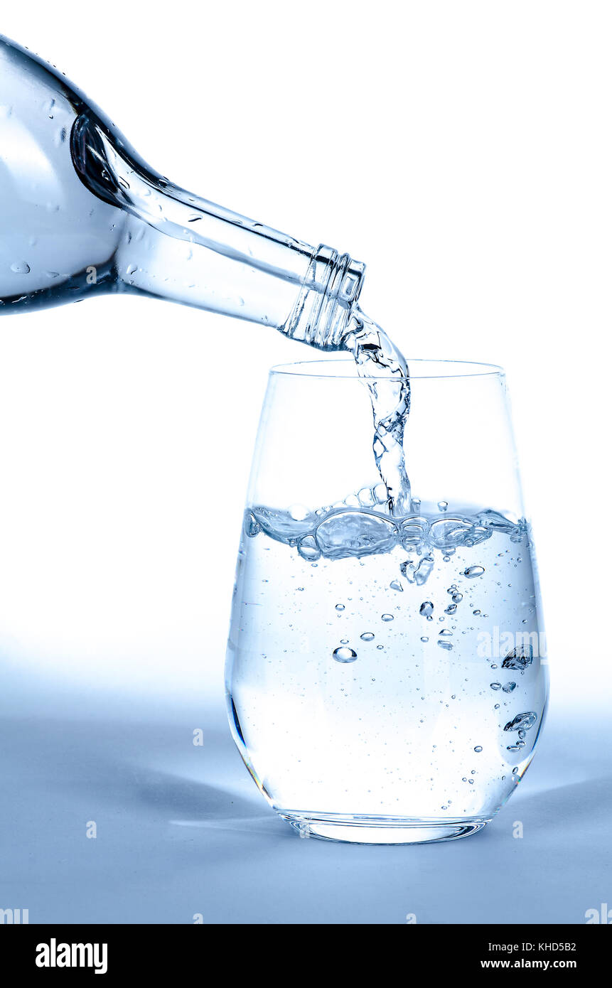 pouring water in a glass - white background Stock Photo - Alamy