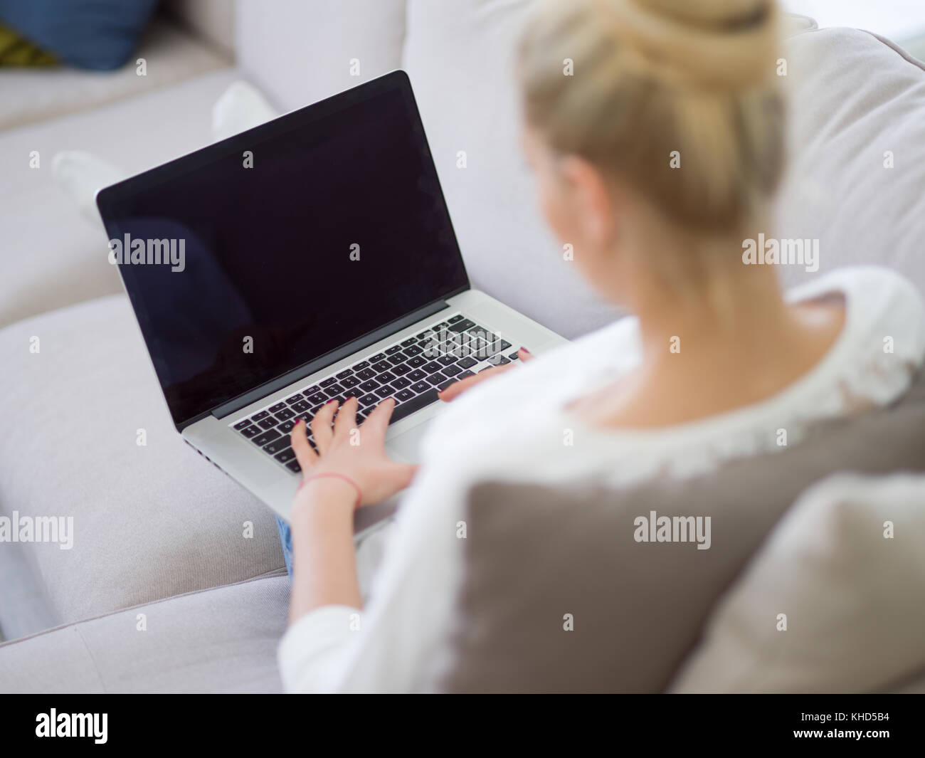 Young woman using her laptop computer in her luxury modern home ...