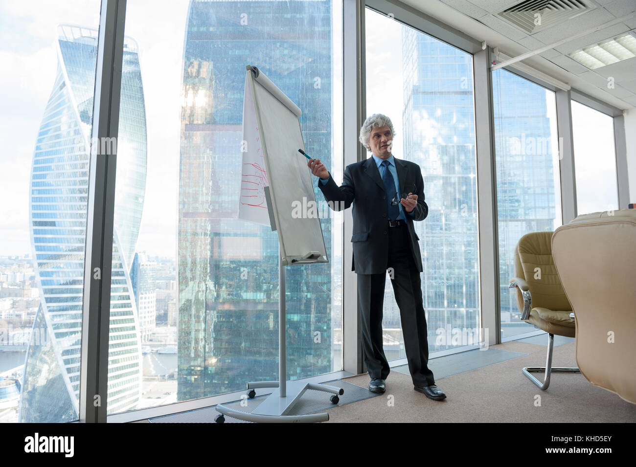 Mature business man making a presentation Stock Photo - Alamy
