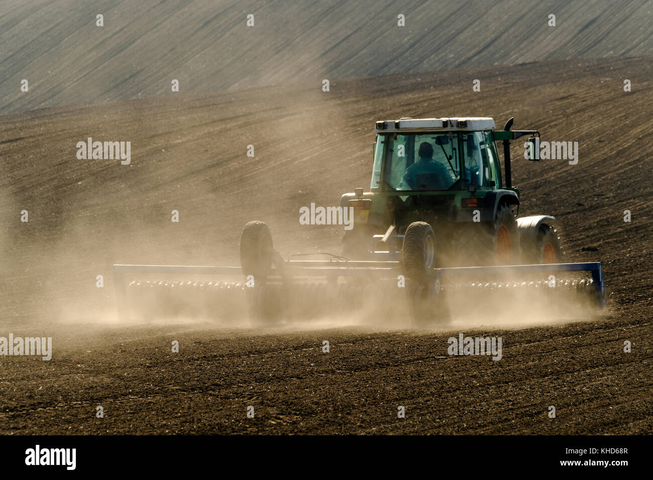 Agricultural tractor working Stock Photo - Alamy