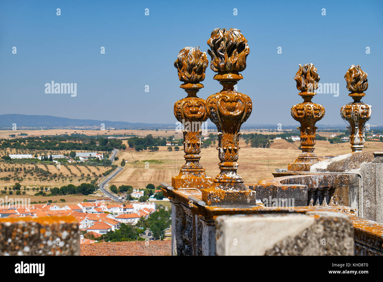 The view of decorative stone torches on the balcony of Evora Cathedral ...