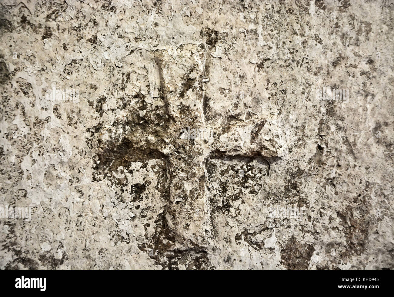 Ancient cross on the stone wall. Background Stock Photo - Alamy