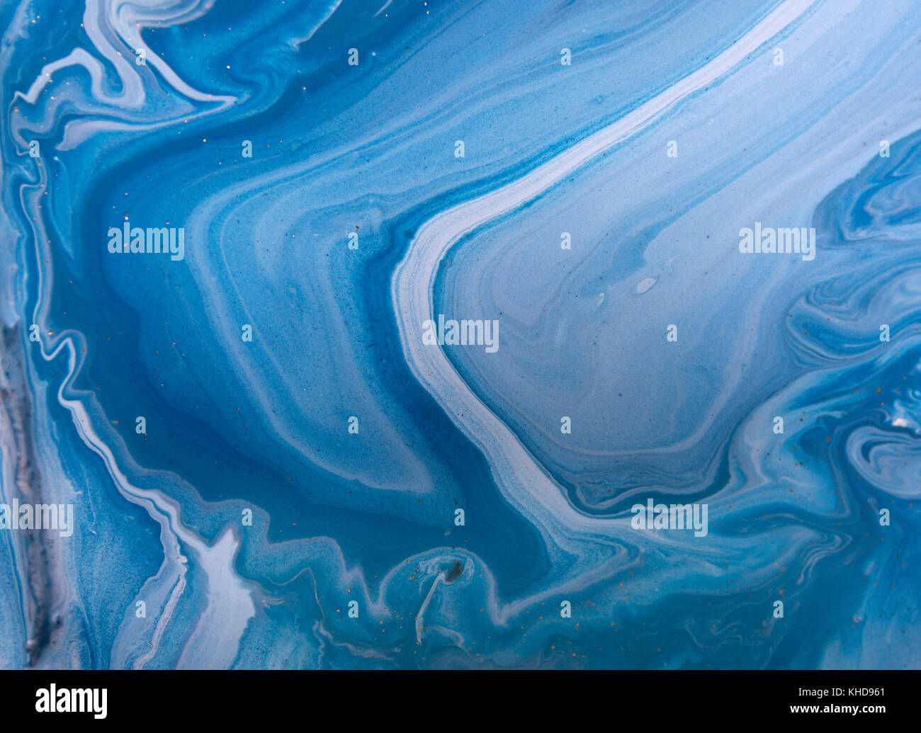 Marbled blue abstract background with golden sequins. Liquid marble ink ...