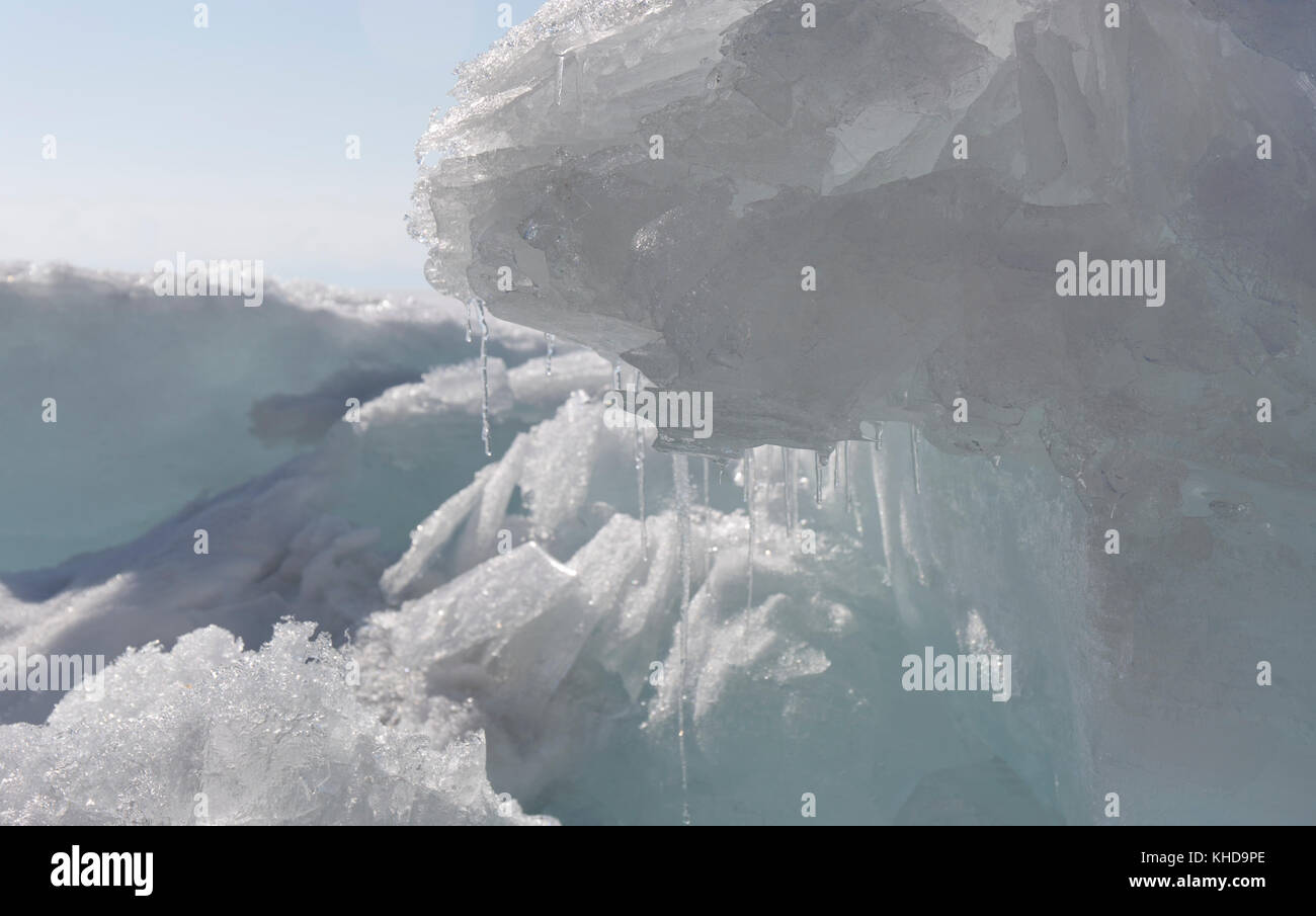 Transparent blue ice hummocks on lake Baikal shore. Siberia winter blur ...