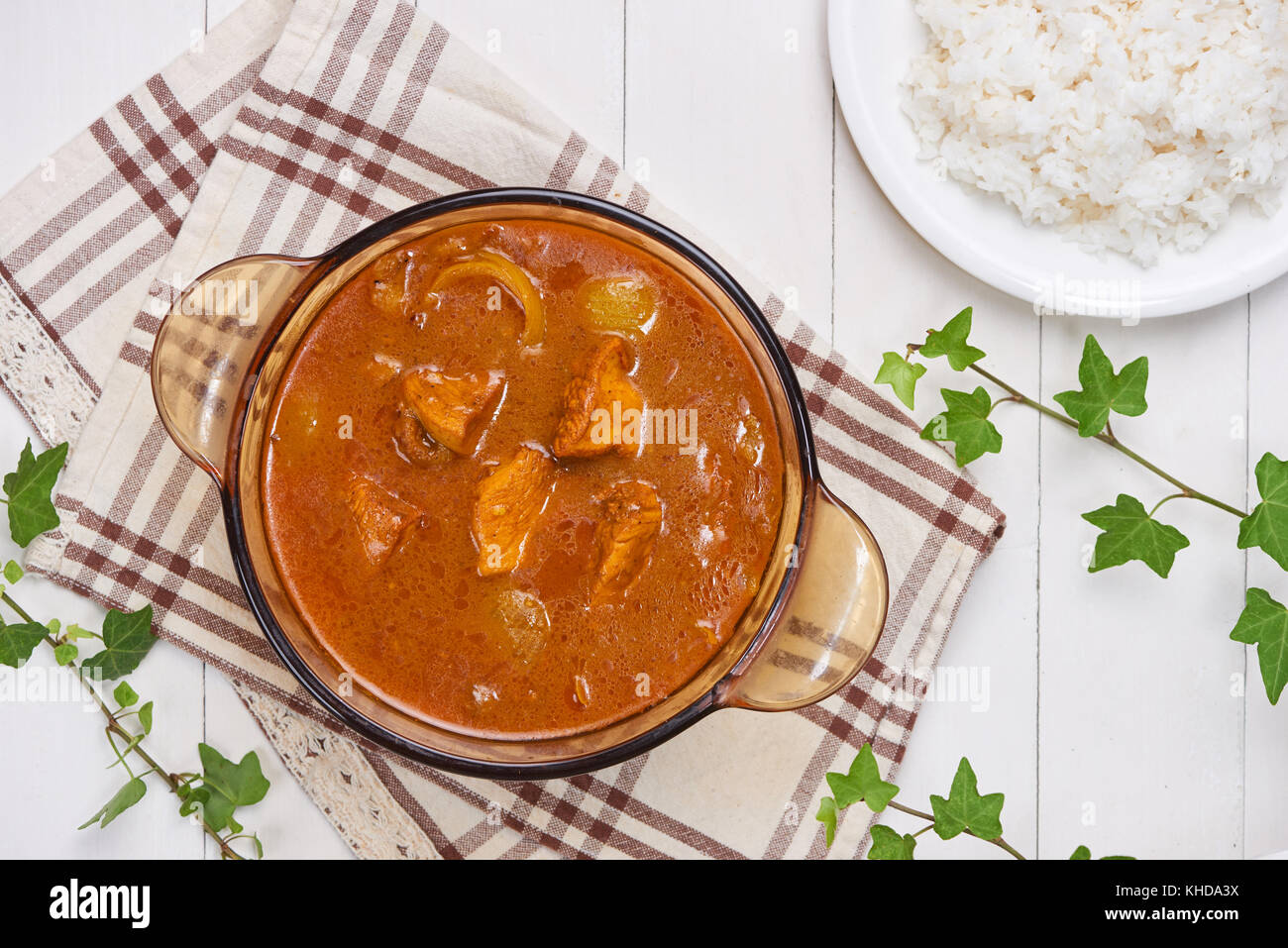 Chicken curry with spice on wooden background Stock Photo - Alamy