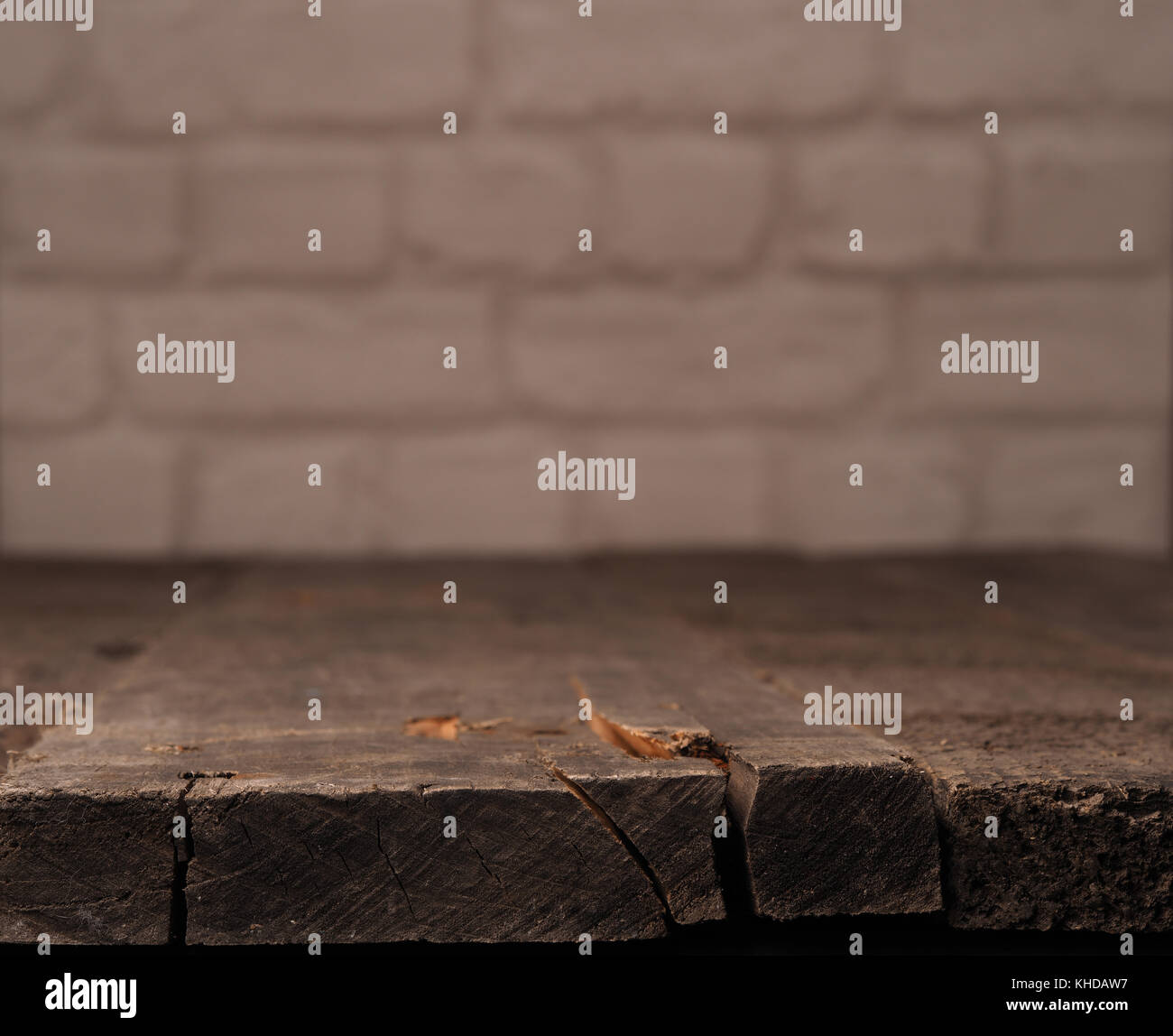 Empty rustic wooden table on a brick wall with space for text or ...