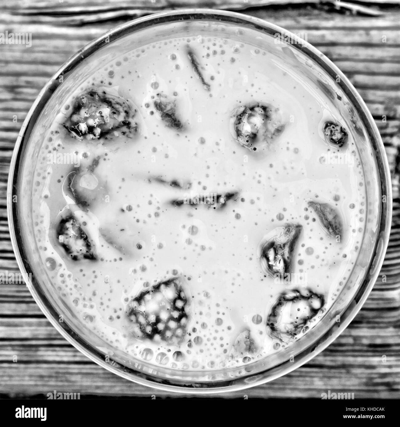 A variety of cold drinks in small bottles with pieces of fruit wooden ...