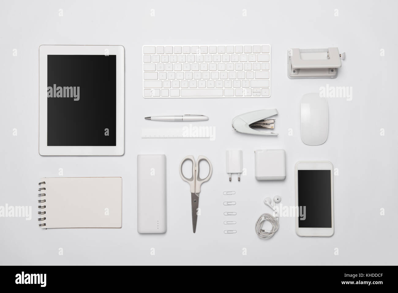 White office supplies. Digital tablet and smartphone on white table ...