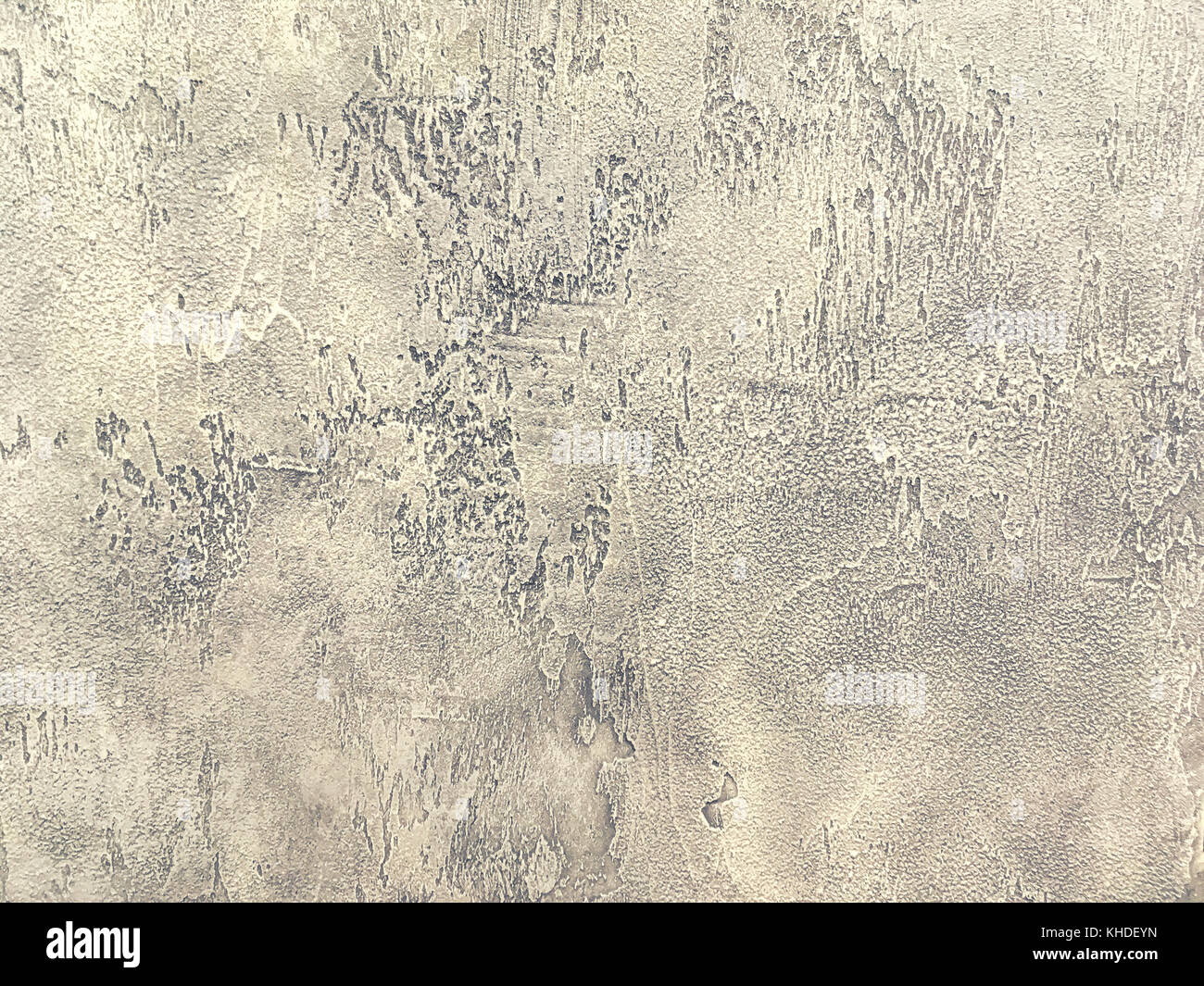 Old light brown wall covered with shabby uneven plaster. Texture of ...
