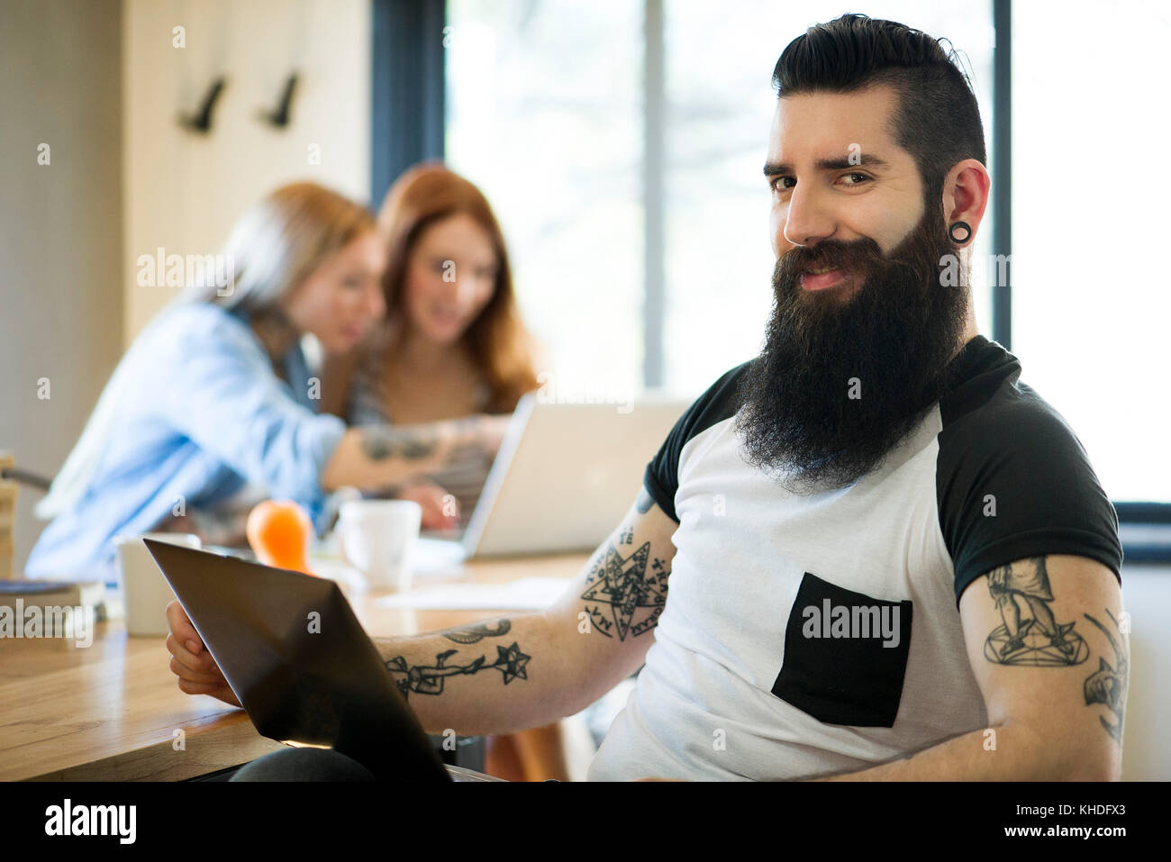 Man using laptop computer, smiling, portrait Stock Photo - Alamy