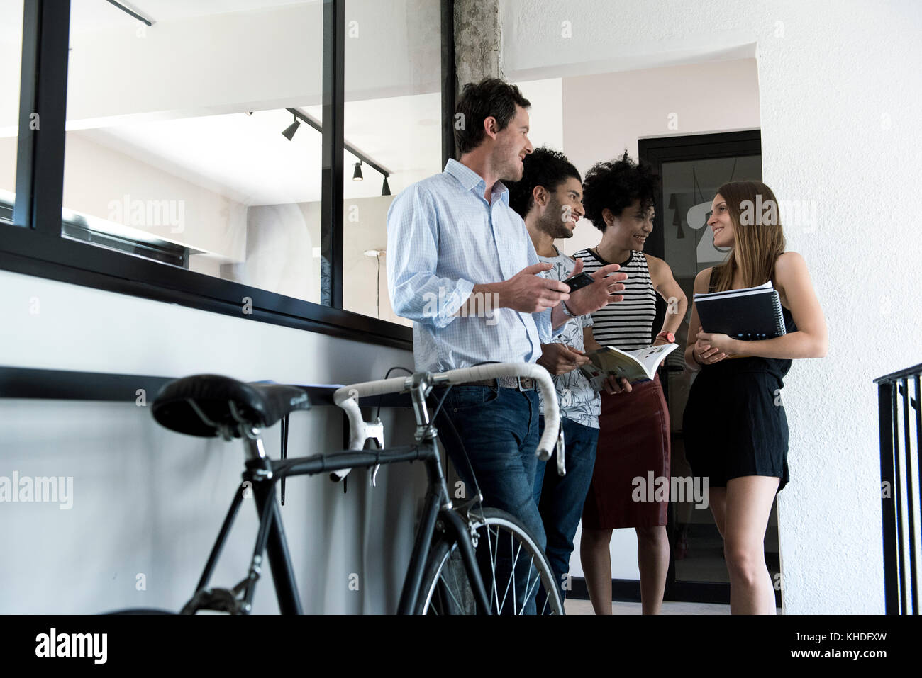Group of college students standing around chatting Stock Photo - Alamy