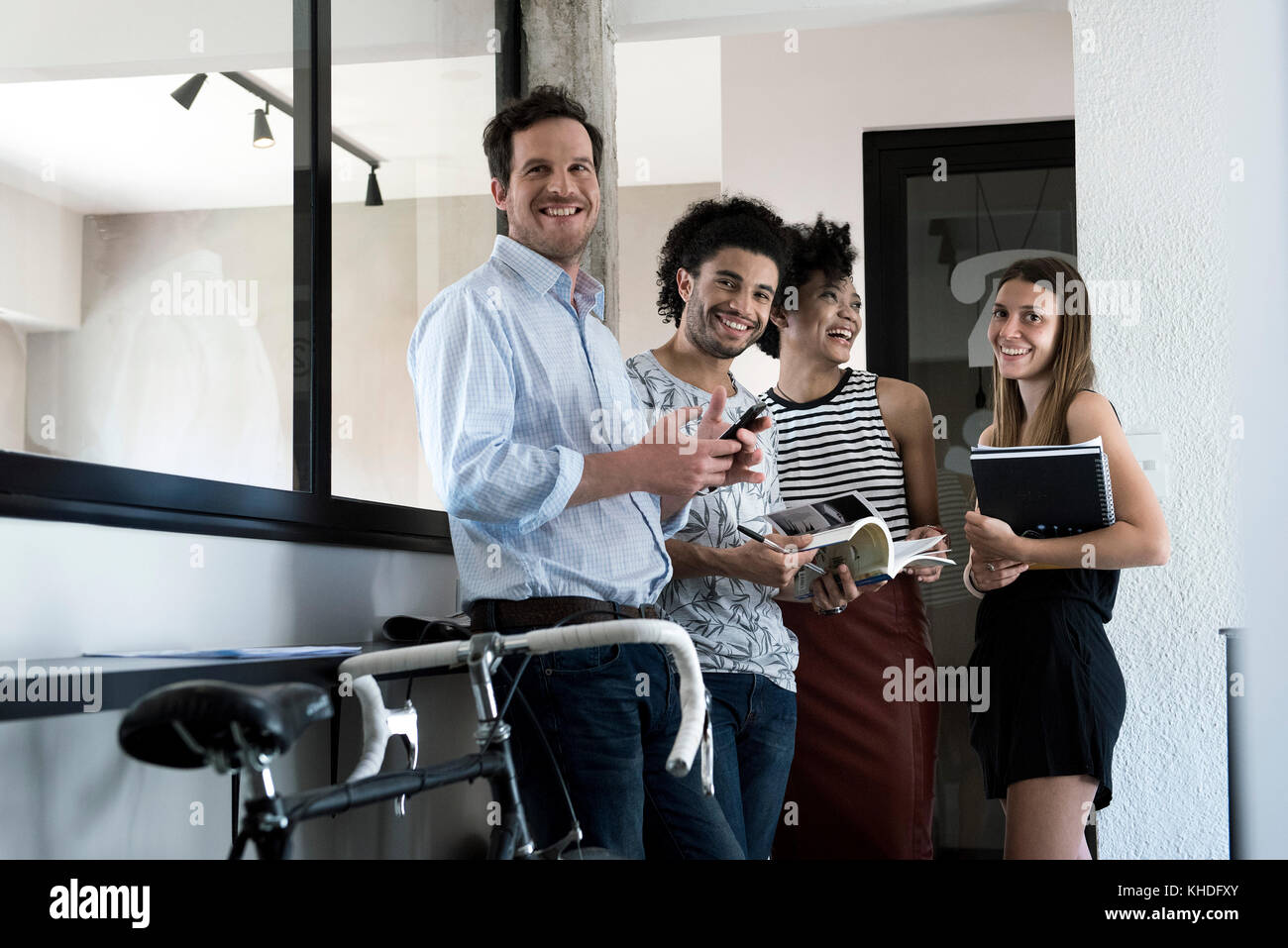 Group of friends standing around chatting Stock Photo - Alamy