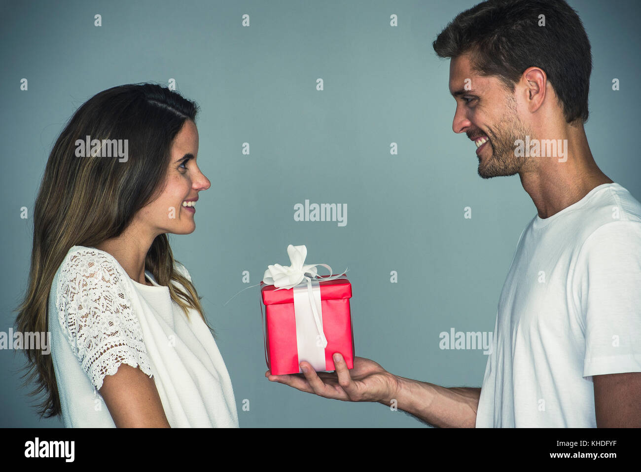 Man giving a gift to his girlfriend Stock Photo - Alamy