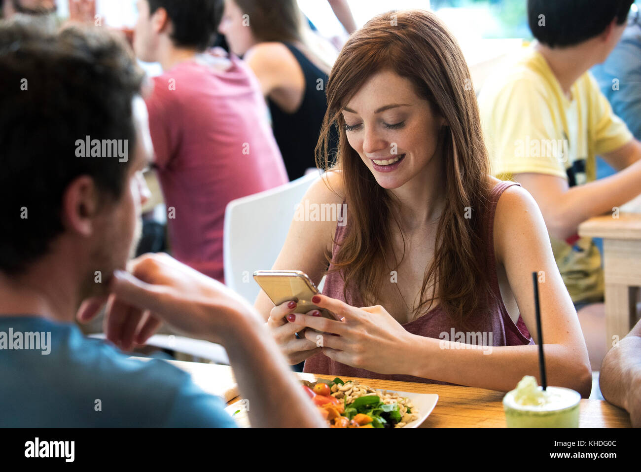 Woman using smartphone in restaurant Stock Photo - Alamy