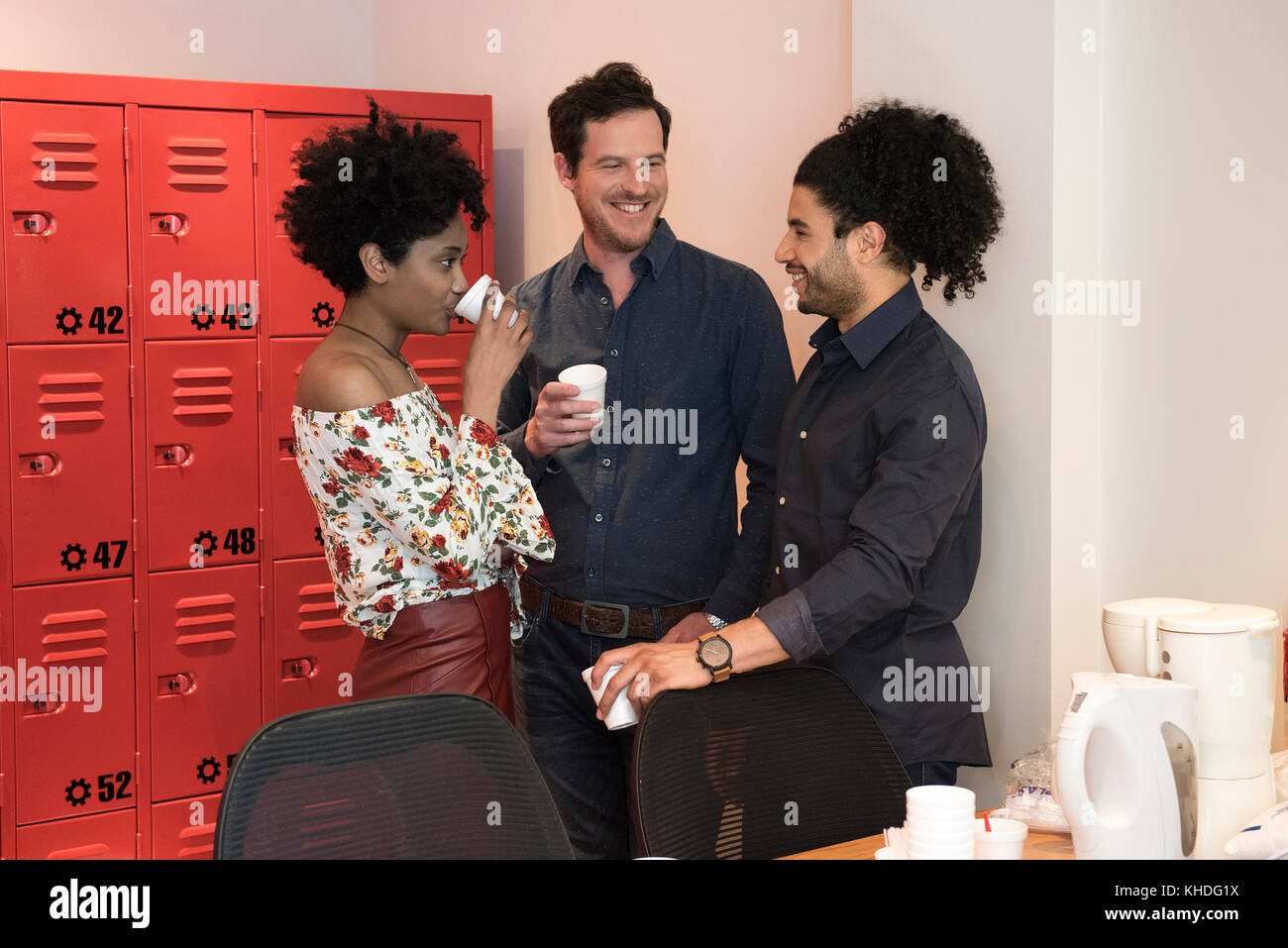 Colleagues taking coffee break in breakroom Stock Photo - Alamy