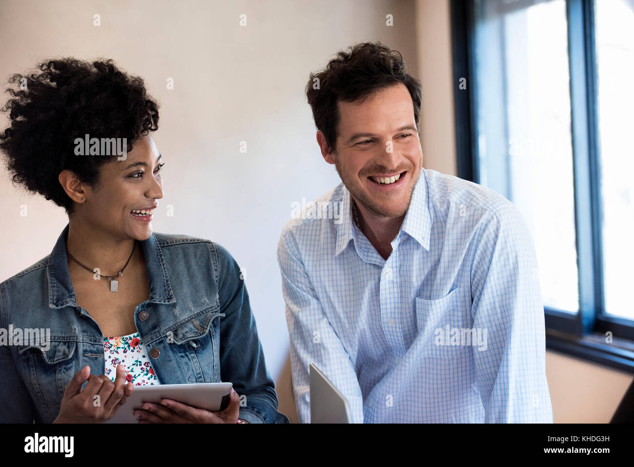 Colleagues chatting in office Stock Photo - Alamy