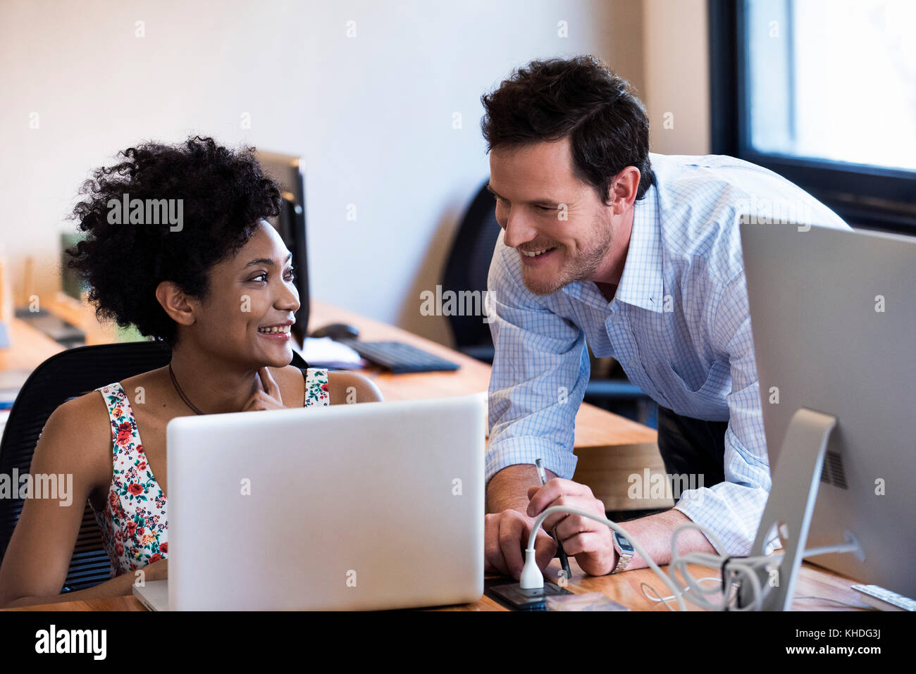 Colleagues chatting in office Stock Photo - Alamy