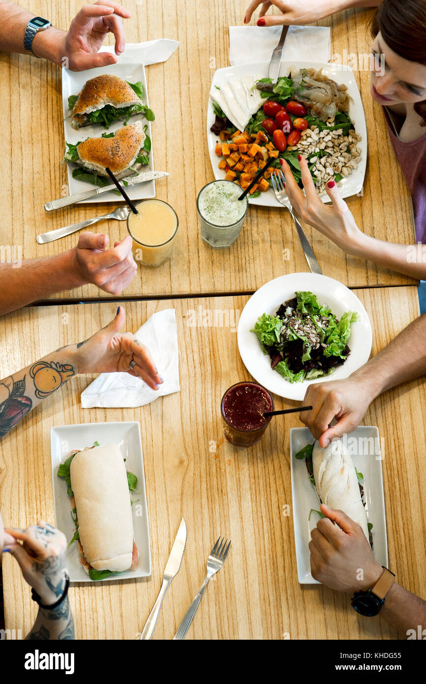Friends dining in restaurant, cropped overhead view Stock Photo - Alamy