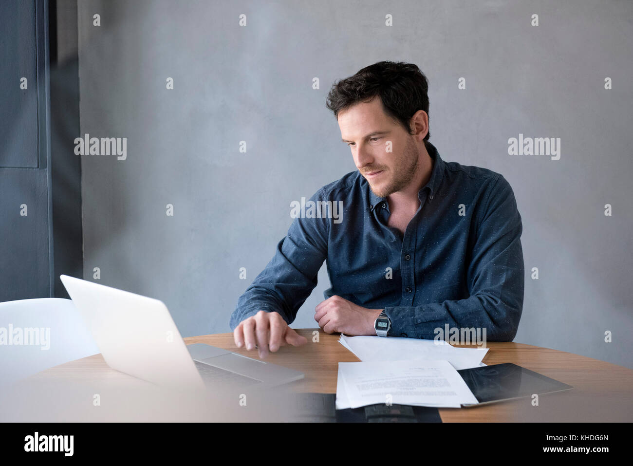 Man using laptop computer in office Stock Photo - Alamy