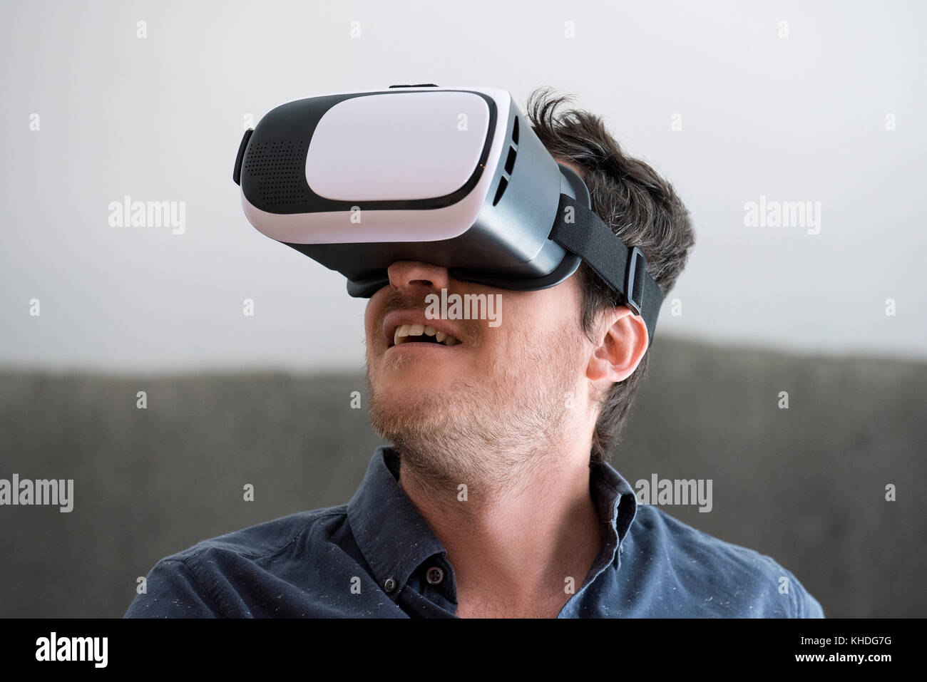 Mid adult man using virtual reality headset Stock Photo - Alamy