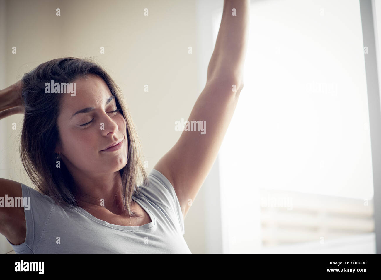 Young woman waking up in morning Stock Photo - Alamy