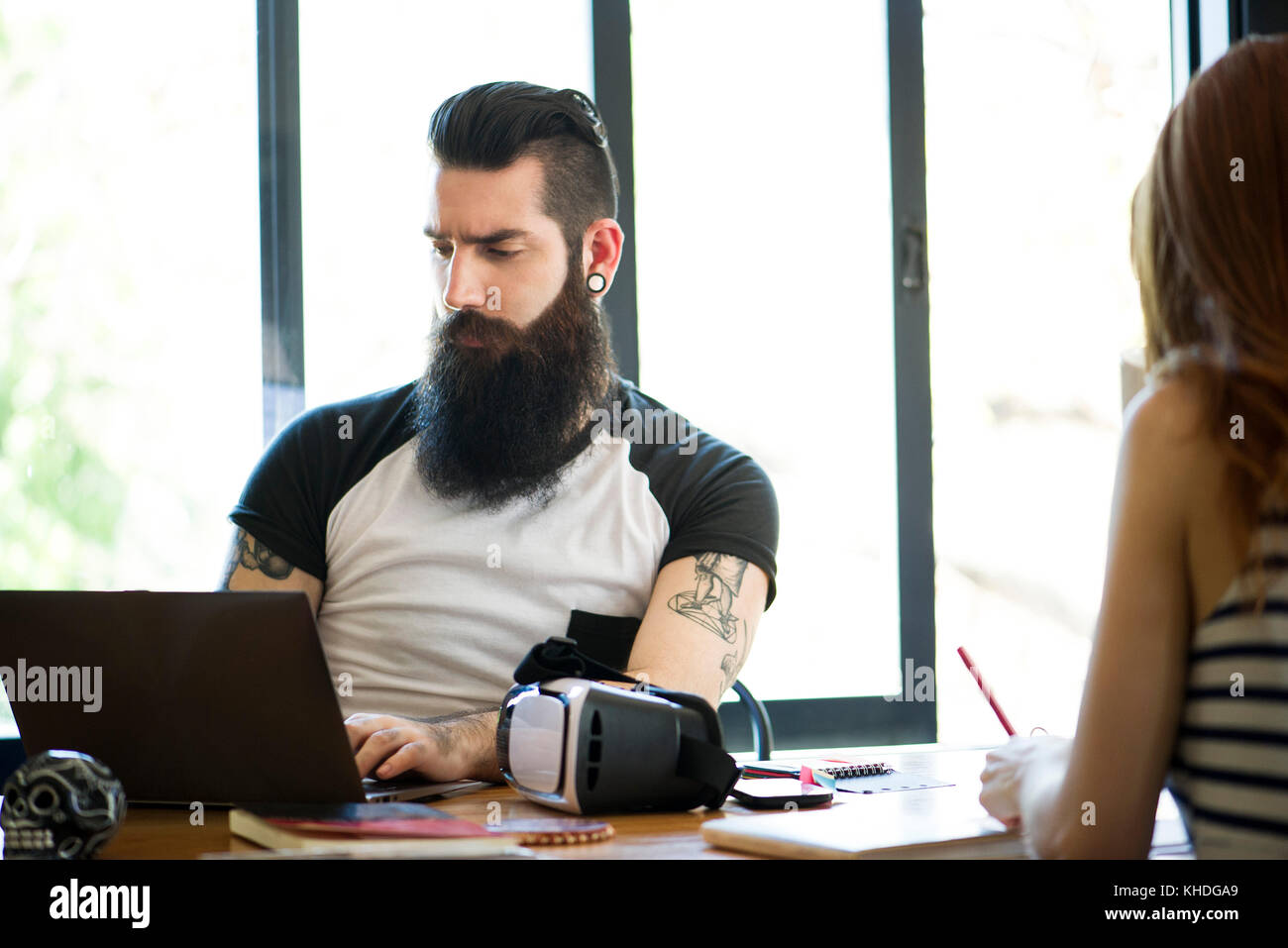 Man working on laptop computer in casual office Stock Photo - Alamy