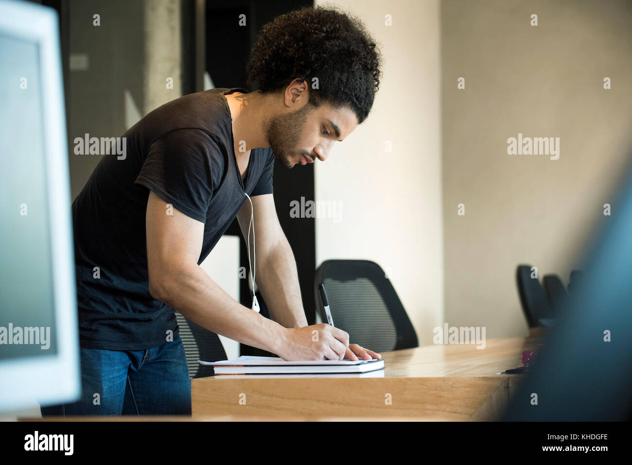 Young man writing Stock Photo - Alamy