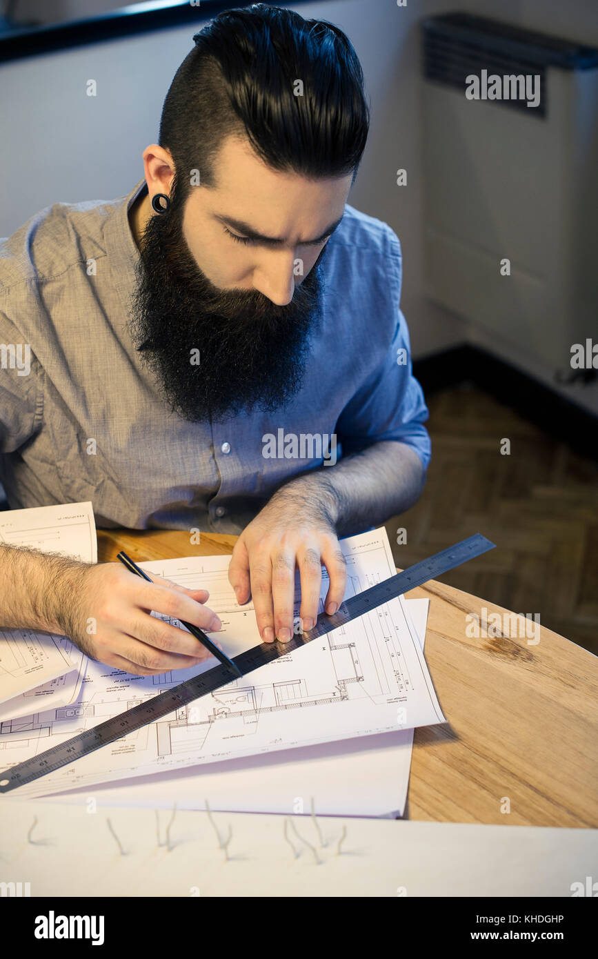 Architect working with blueprints in office Stock Photo - Alamy