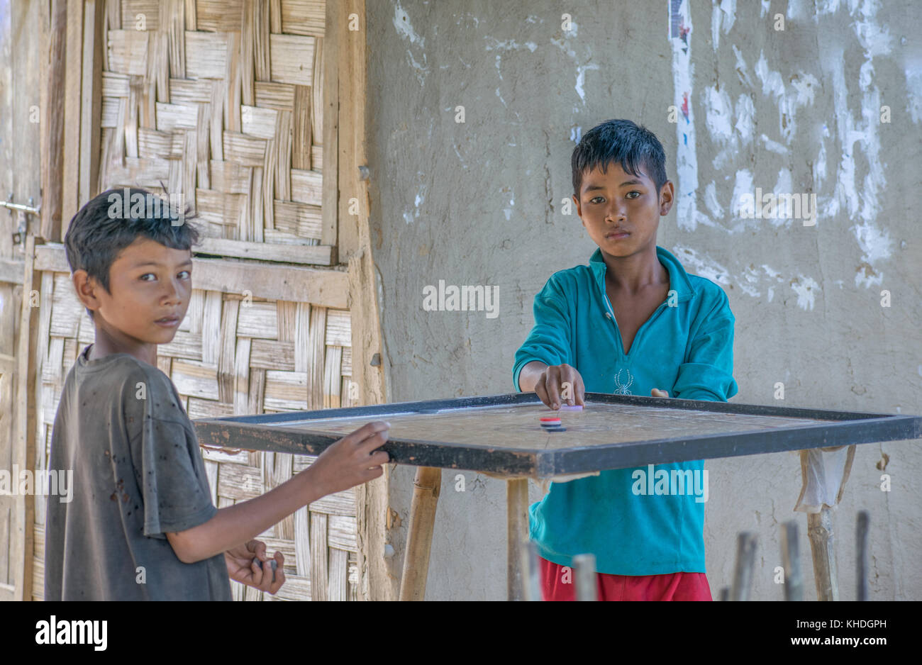 Two children playing carrom/karrom game at the countryside, Karbi ...