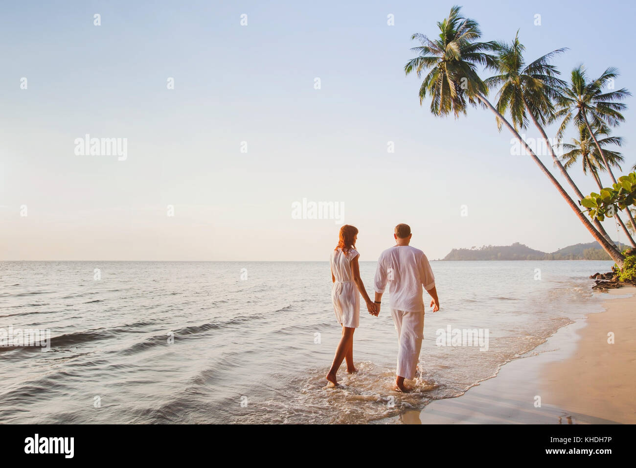 romantic young couple walking together on beautiful exotic tropical ...