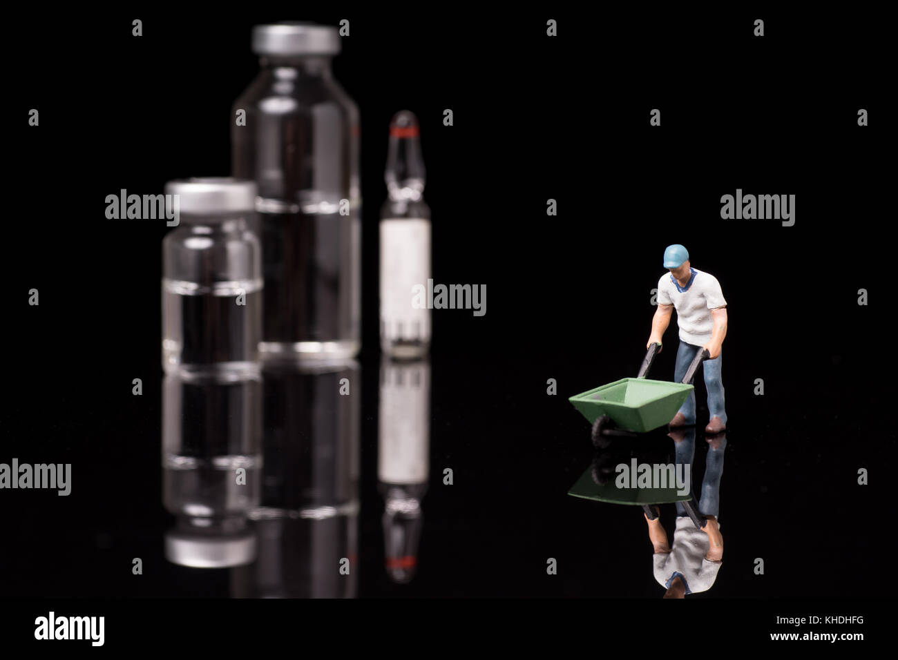 Medical vials with clear liquid and work men Stock Photo - Alamy