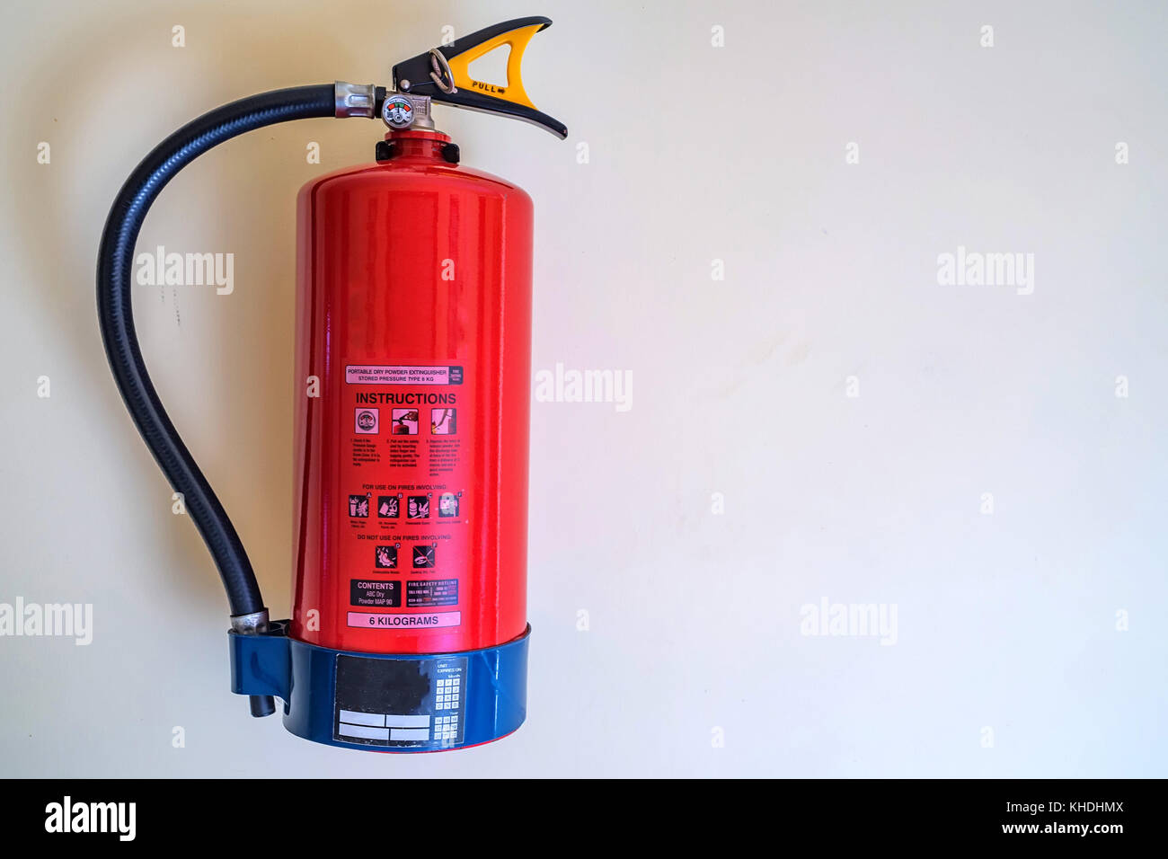 Red fire extinguisher Stock Photo - Alamy