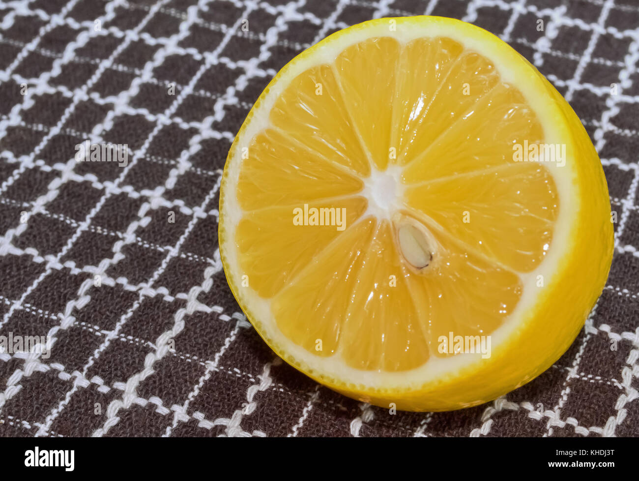 Closeup of one half of a lemon placed on the table Stock Photo - Alamy