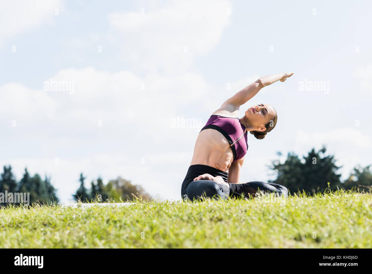 woman stretching in lotus pose Stock Photo - Alamy