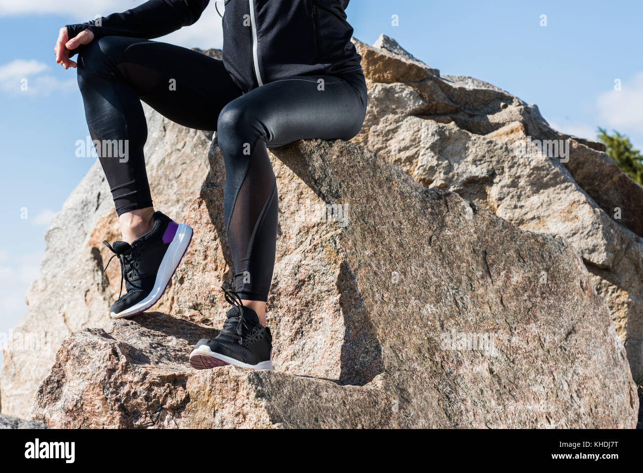 woman sitting on rocks Stock Photo - Alamy