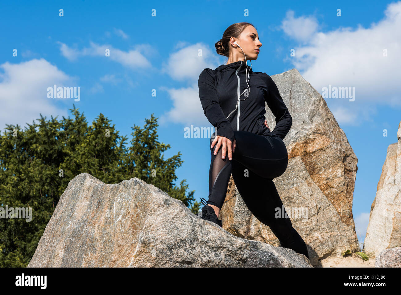 young sportive woman on rocks Stock Photo - Alamy