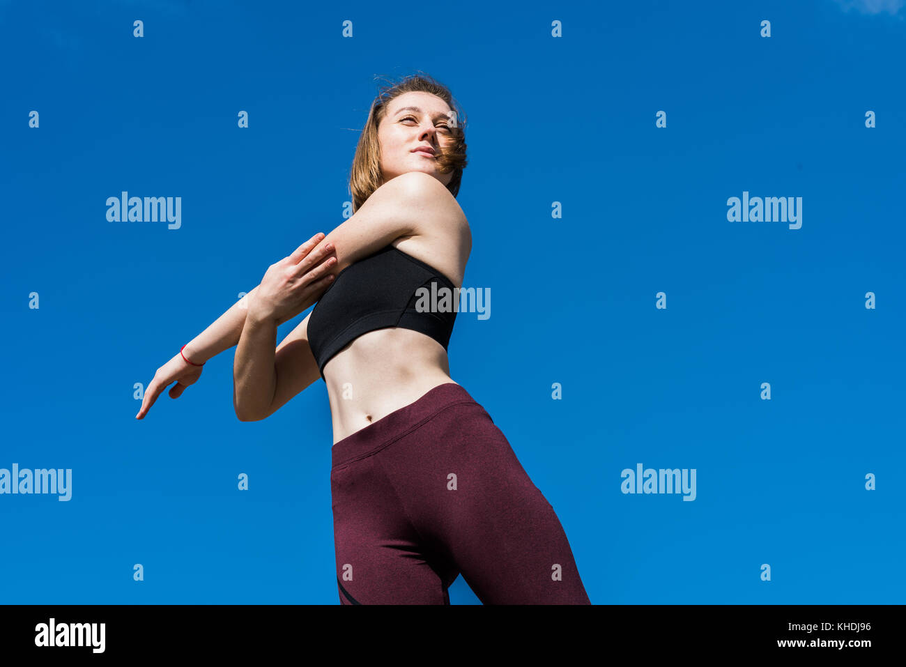 athleric woman stretching hand Stock Photo - Alamy