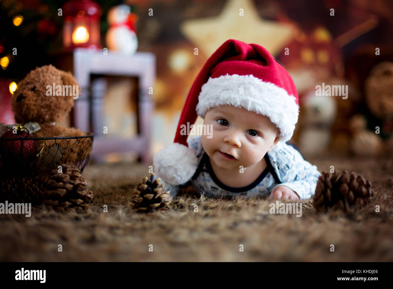 Portrait of newborn baby in Santa clothes in little baby bed, winter ...