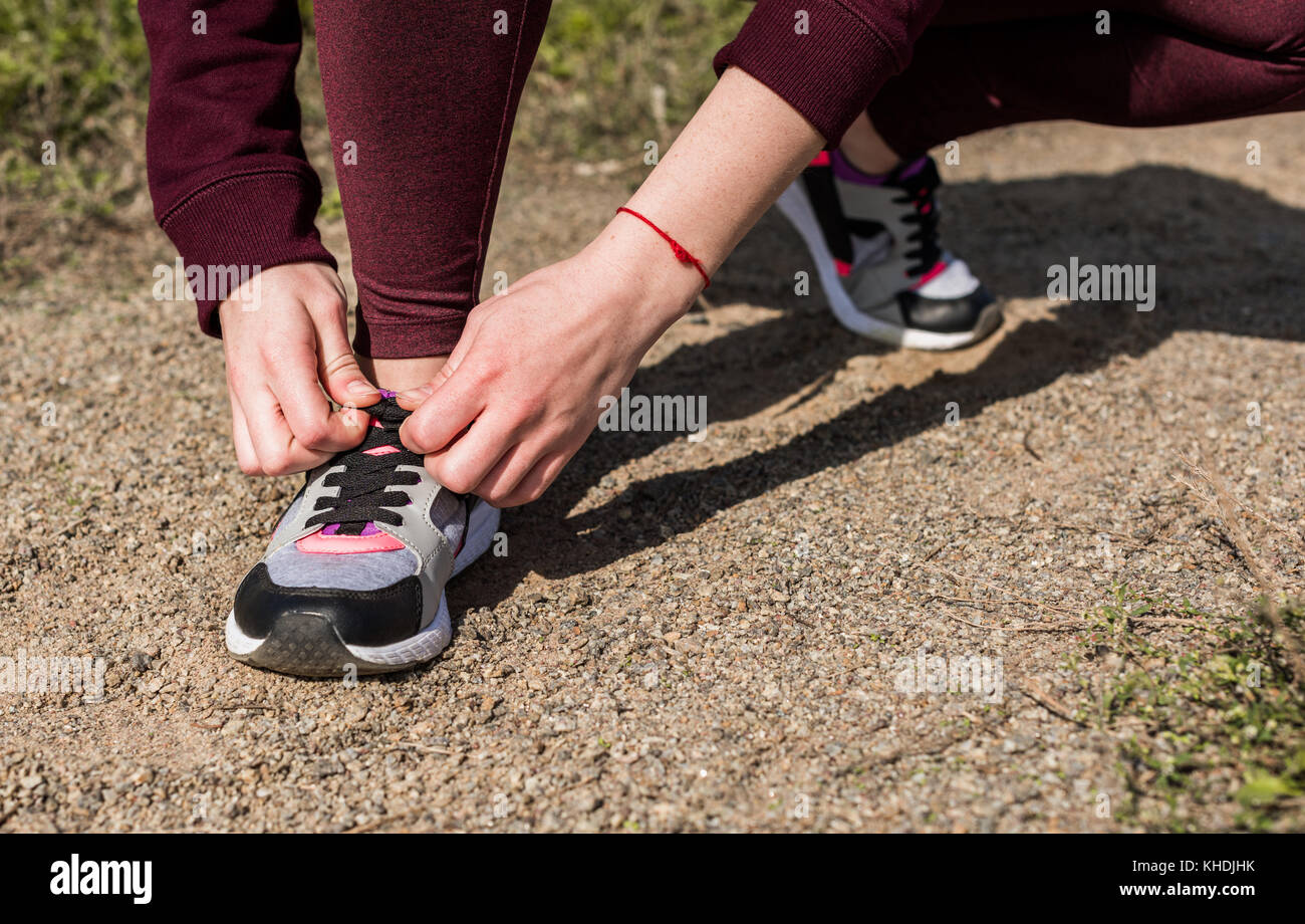woman lacing shoe Stock Photo - Alamy
