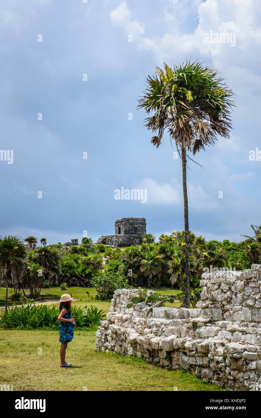 Girl looking a palm tree in the mayan site of Tulum, Quintana Roo ...