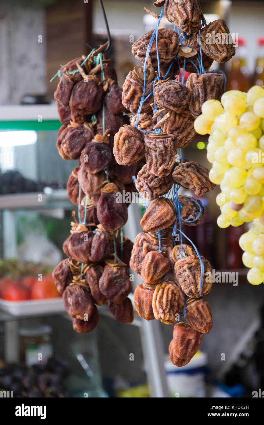 dried persimmon (Diospyros kaki) hanging on the street market in ...