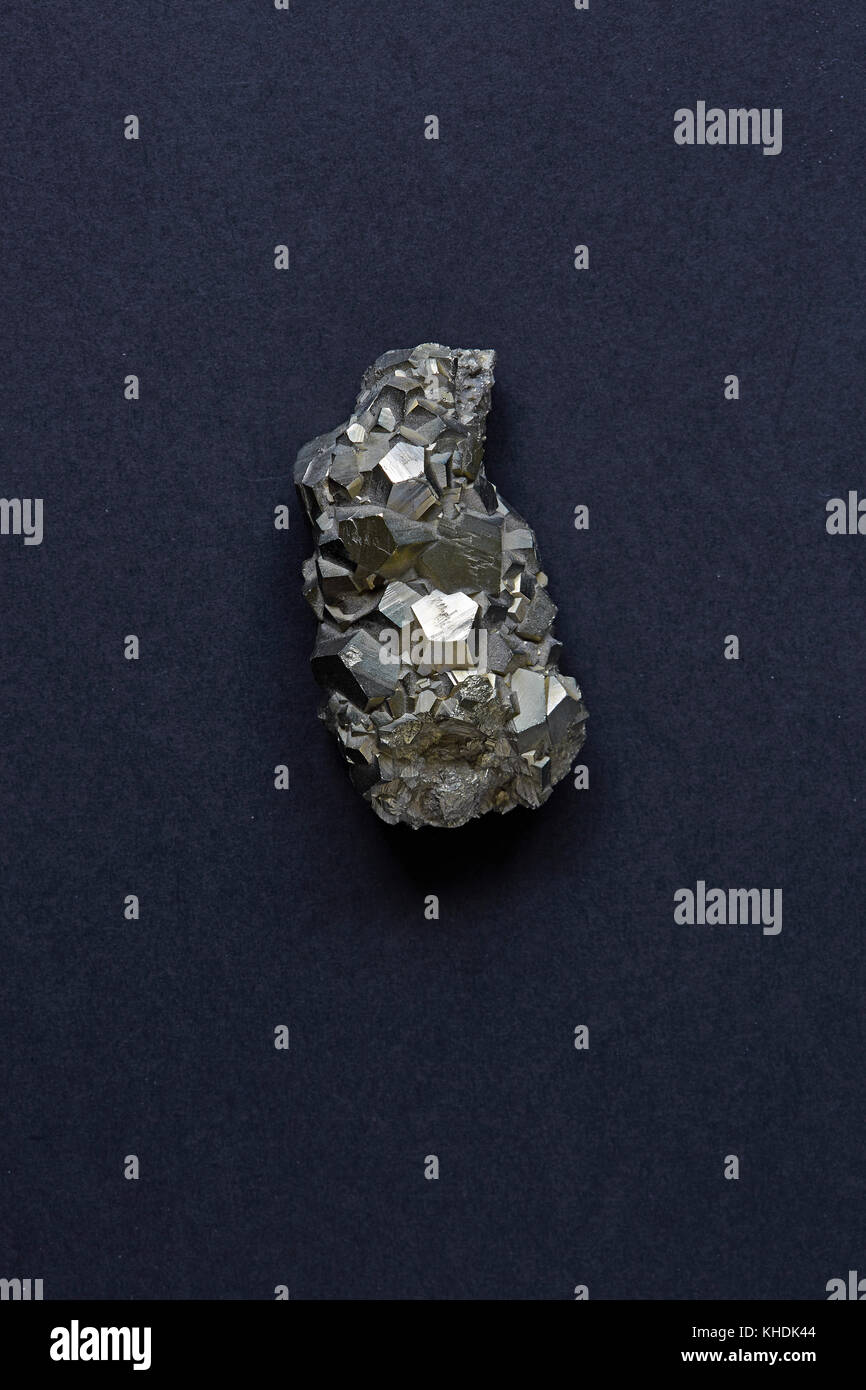 A specimen of a rough pyrites rock with a dark background Stock Photo ...