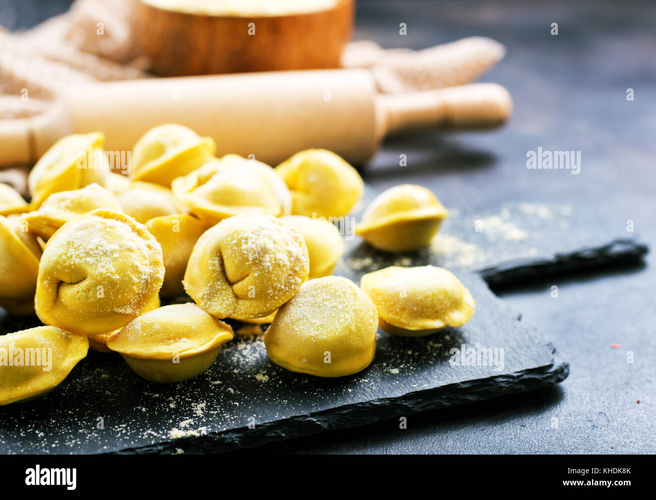 raw dumplings on board and on a table Stock Photo - Alamy