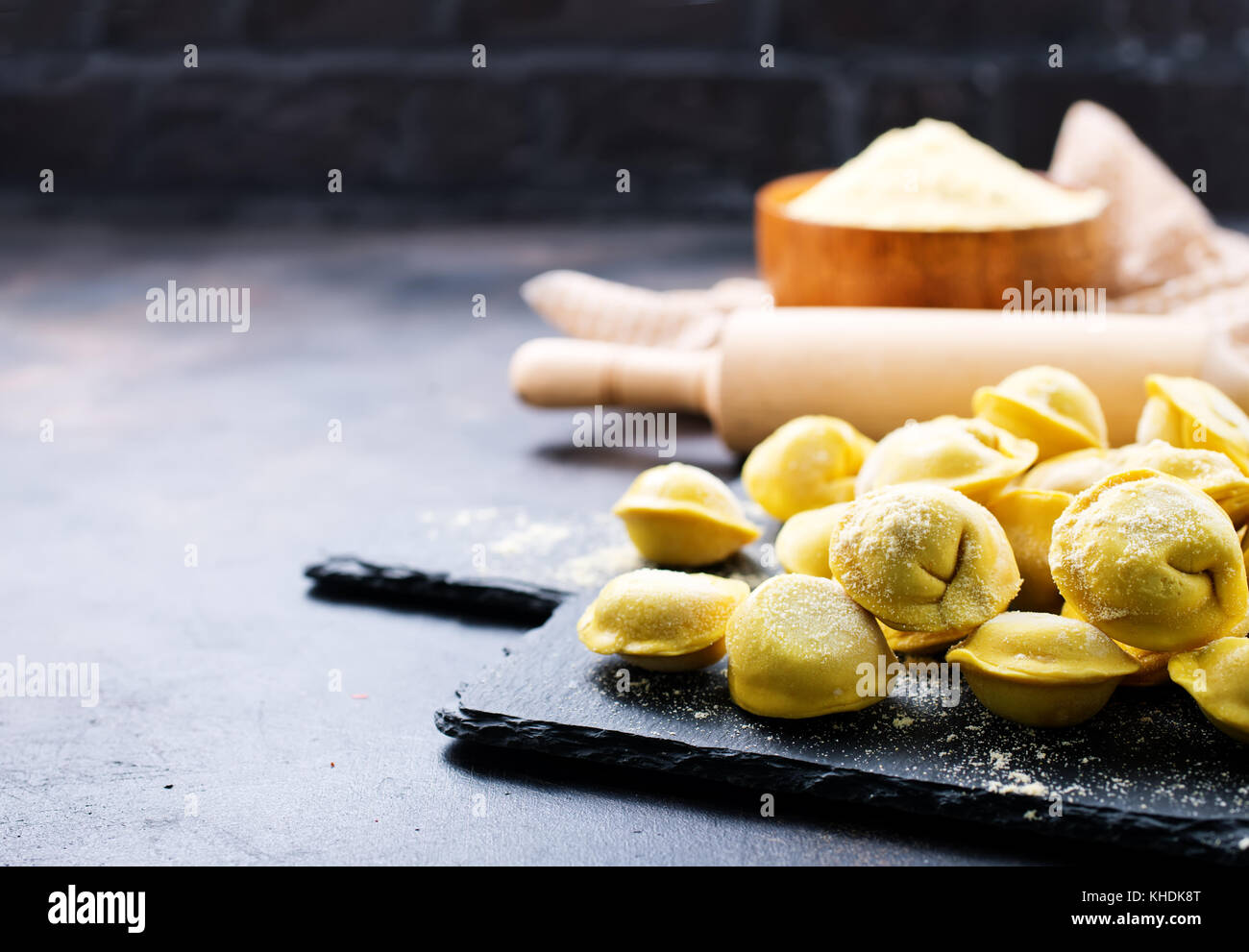 raw dumplings on board and on a table Stock Photo - Alamy