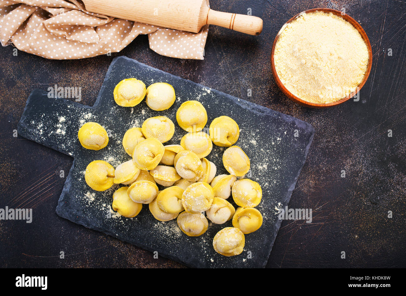 raw dumplings on board and on a table Stock Photo - Alamy