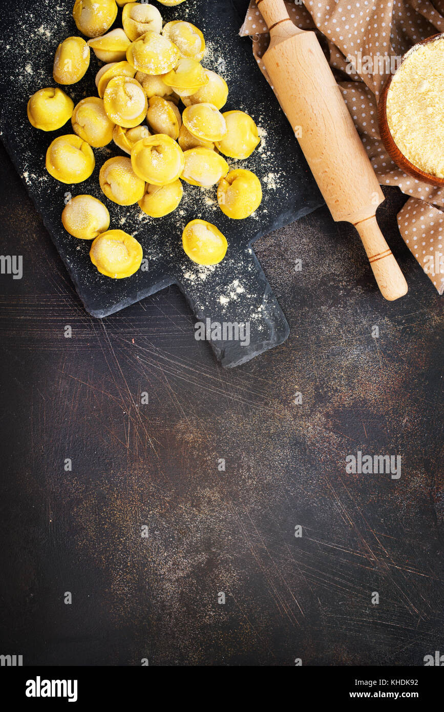 raw dumplings on board and on a table Stock Photo - Alamy