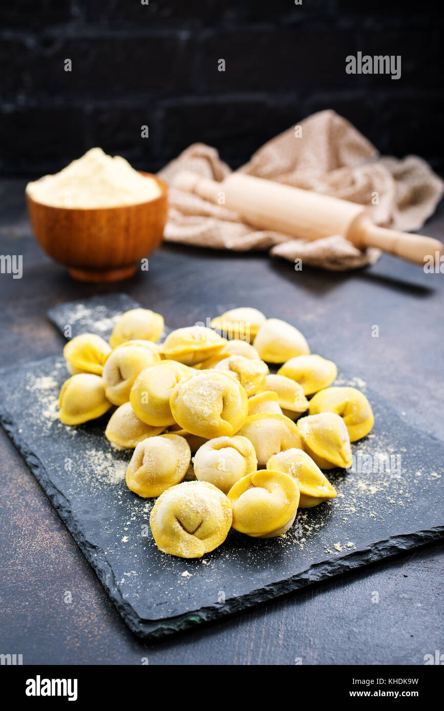 raw dumplings on board and on a table Stock Photo - Alamy